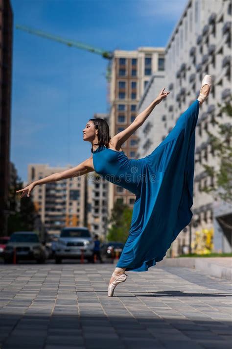 Beautiful Asian Ballerina In Blue Dress Posing In Splits Outdoors
