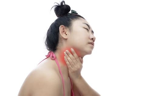 젊은 아시아 여성은 그녀의 목을 만지고 흰색 배경에서 목구멍에 통증을 느끼고 갑상선 문제가있는 여성 인후통을 가진 여성 통증