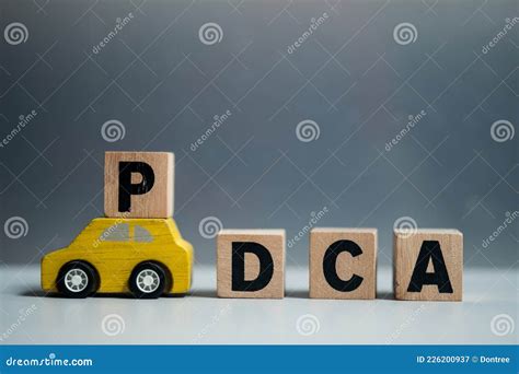 Toy Car Moves A Wooden Cube With The Letter P To Complete The Word Pdca
