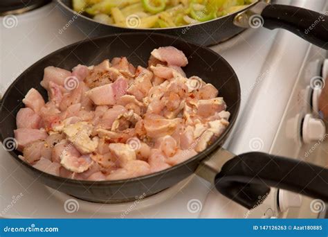 Chicken Is Fried In A Frying Pan On An Electric Stove Home Cooking