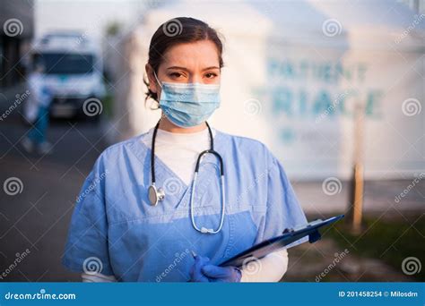 Young Female Ems Key Worker Doctor Standing In Front Of Healthcare Icu