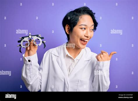 Beautiful Asian Optical Girl Wearing Coat Holding Optometry Glasses