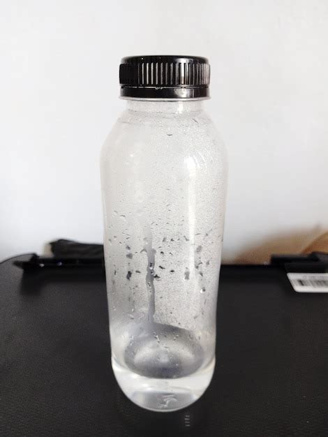 Premium Photo Close Up Of Glass Bottle On Table