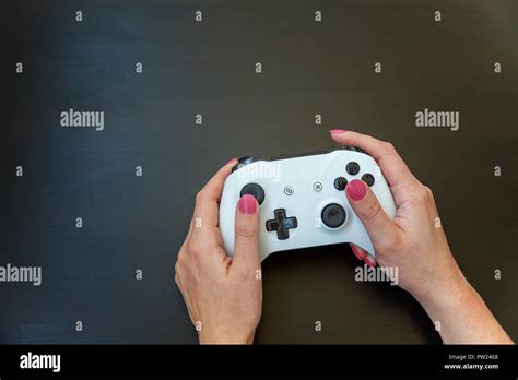 Woman Hand Holding White Joystick Gamepad Game Console On Black