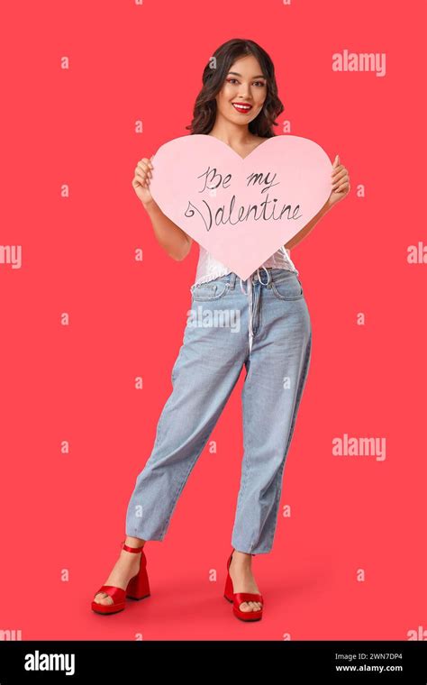 Beautiful Young Happy Asian Woman With Paper Heart On Red Background