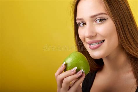 Beautiful Young Woman With Dental Braces Smiling While Enjoying A