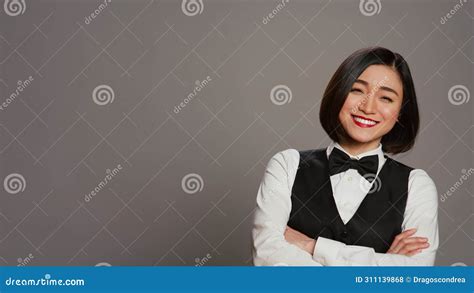Asian Woman Hotel Concierge Wearing Elegant Uniform With Bow Stock