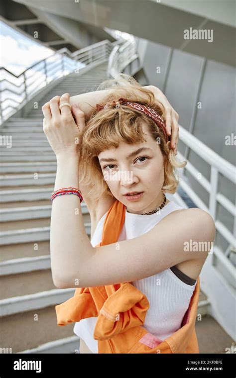 Vertical Portrait Of Young Woman Posing Outdoors In Urban Setting
