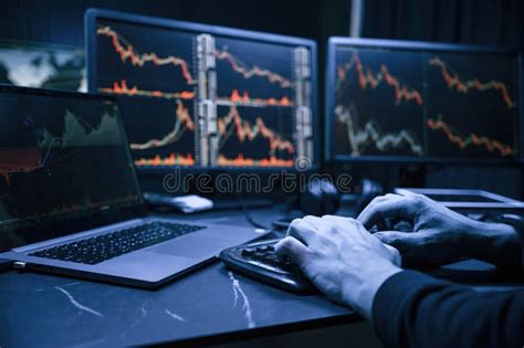 Financial Analyst Working On A Computer With Multi Monitor Workstation