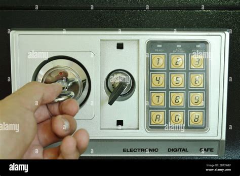 Hand Twist Key To Hole For Open Safe Box With Security Electronic Number Stock Photo Alamy