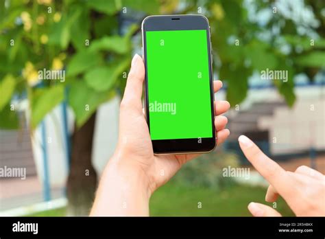 Woman Using Smartphone With Green Screen Outdoors Closeup Gadget Display With Chroma Key