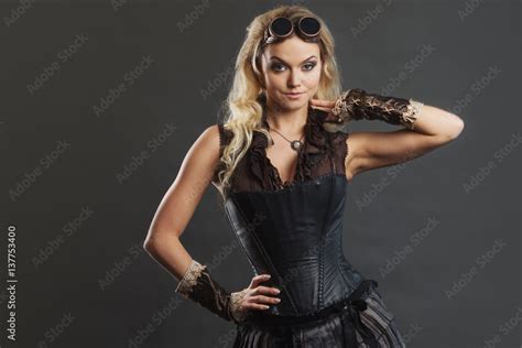 Portrait Of A Beautiful Steampunk Woman In Aviator Glasses Over Grey
