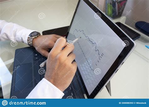 Worker Analyzing Statistics On A Laptop In The Office Stock Image