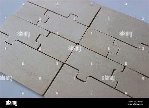 rectangular panel of tightly folded plywood puzzles on a white surface