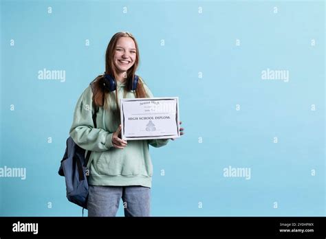 Portrait Of Smiling Student Holding High School Diploma Celebrating