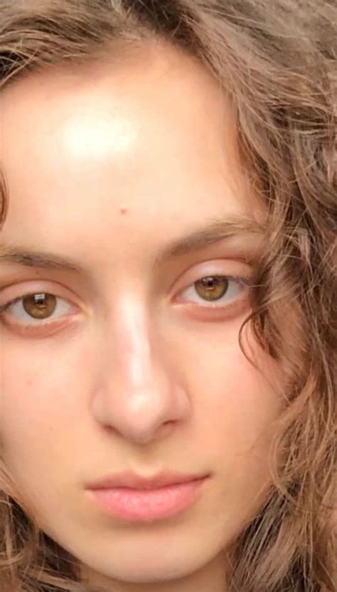 A Close Up Of A Person With Long Hair And Brown Eyes Looking At The Camera