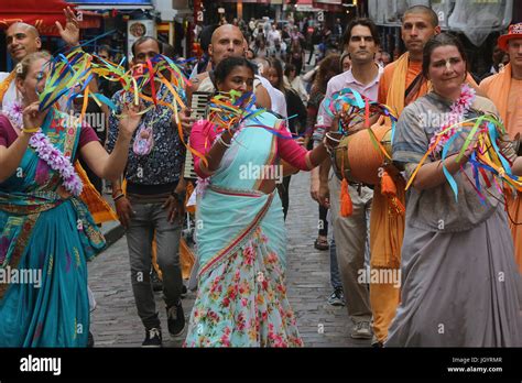Iskcon Devotees Performing A Harinam Devotional Walk With Dancing And