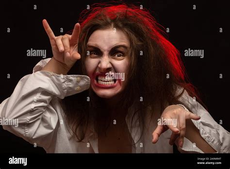 Fun Crazy Young Woman With Fluffy Hair On Black Background Make Grimace