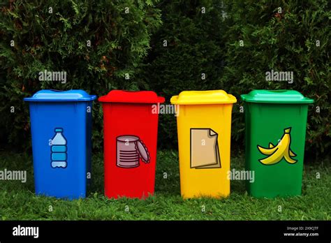 Waste Sorting Recycling Bins With Illustrations Of Different Garbage Types Outdoors Stock Photo