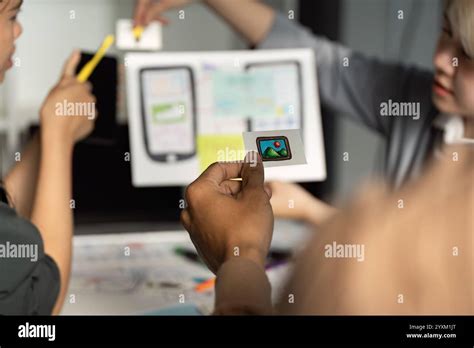 Creative Ux Ui Design Team Collaborating On Innovative Mobile App Interface With Wireframes And