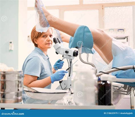 Doctor Examining Woman With Colposcope In Modern Clinic Stock Image