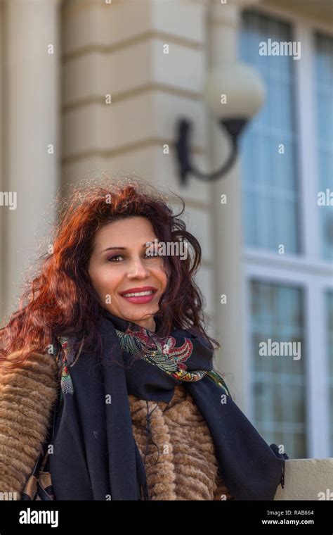 Classy Woman Smiling With Arabic Somatic Features Walking In Italian