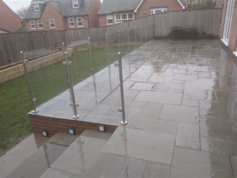 Indian Sandstone Raised Patio With A Glass Balustrade Raised Planting