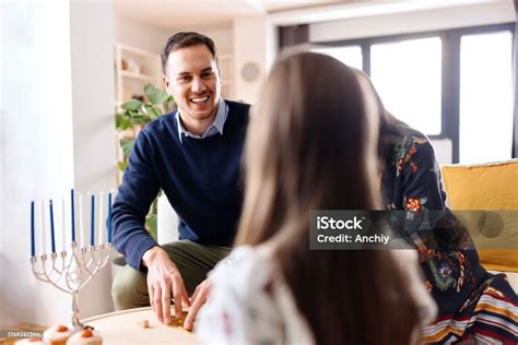 Caring Father Smiling With His Daughter While Celebrating Hanukkah