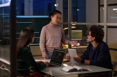Group Of Coworkers Correcting Code In Evening Stock Image Image Of Evening Night 309241895