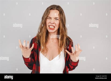Freestyle Young Woman With Freckles Standing Isolated On Grey
