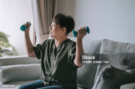 아시아 중국 시니어 여성 복용 자신 의 그녀 운동 와 아령 에 집에서 물리치료에 대한 스톡 사진 및 기타 이미지 물리치료