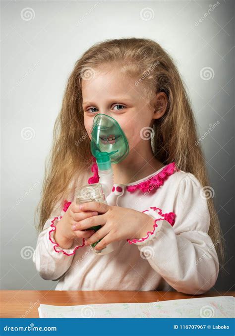 Girl Performs Physiotherapy Inhalation In The Hands Of Nebulizer Stock