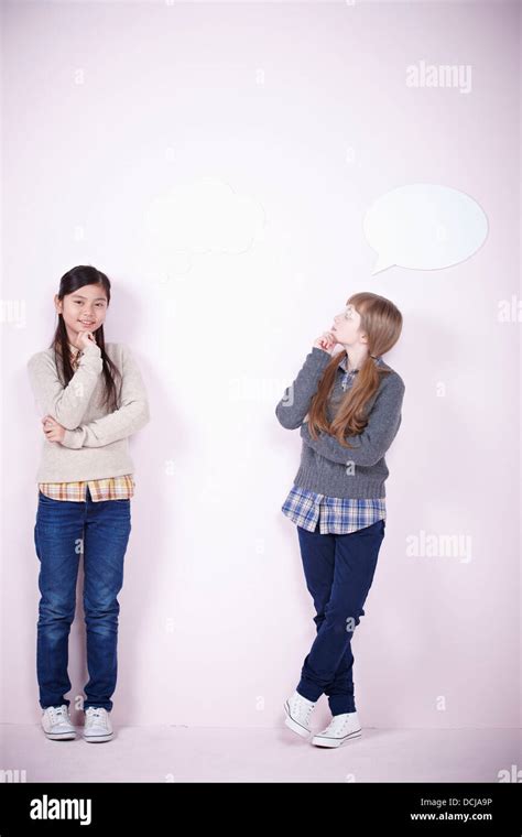 Two Girls Standing Together While One Girl Has Speech Bubble Stock