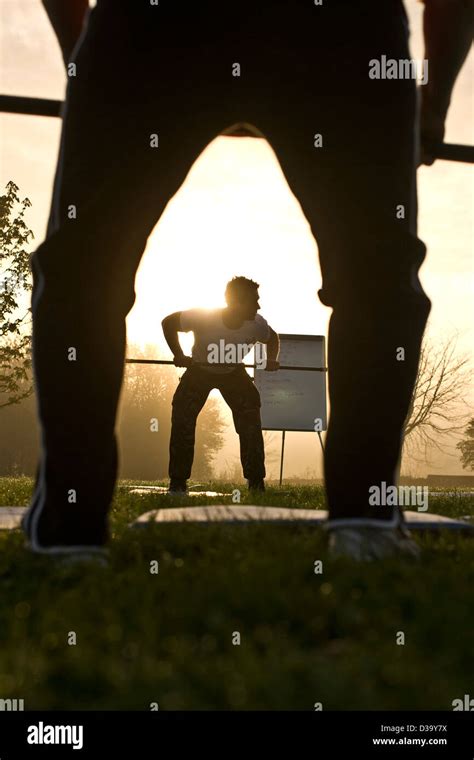 Fitness Instructor Leading Weight Lifting Class At Luxury Boot Camp
