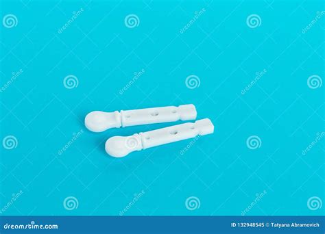White Lancet Needle For A Glucometer Lies On A Blue Background Stock