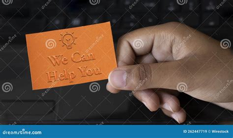 Hand Holding A We Can Help You Message On The Card Stock Image