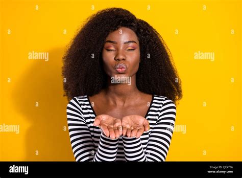 Photo Portrait Of Curly Girl In Striped Shirt Sending Air Kiss With