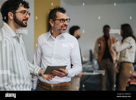 Multi Generational Business Team Analyzing Data Collaborating And