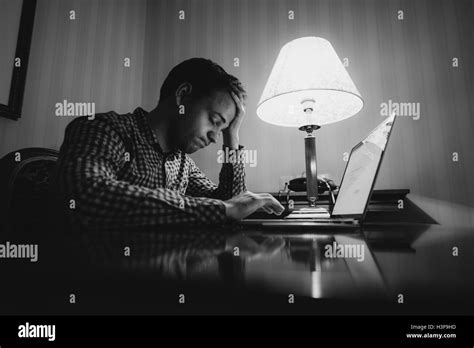 Frustrated Young Business Man Working On Laptop Computer At Office
