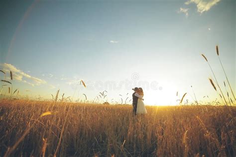 Happy Bride And Groom Hug Each Other In The Park At Sunset Wedding Stock Photo Image Of