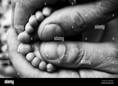 Mother Is Doing Massage On Her Baby Foot Closeup Baby Feet In Mother Hands Stock Photo Alamy