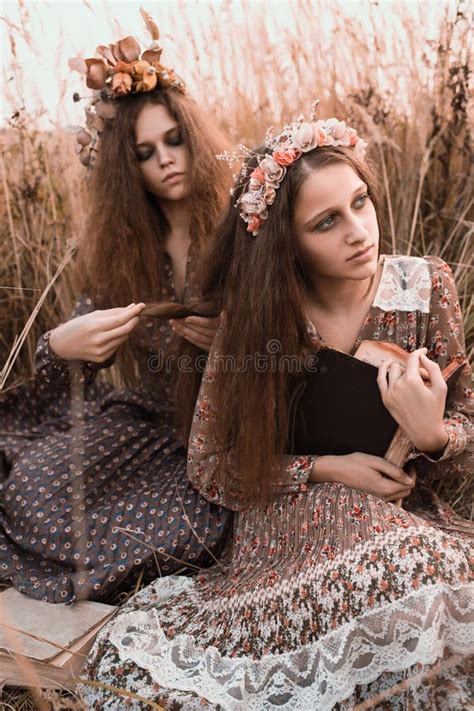 Fashion Portrait Of Two Beautiful Girls At The Sunset Field Wearing