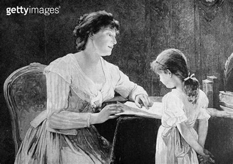 Mother Teaches Daughter At The Table Pointing At A Book 이미지