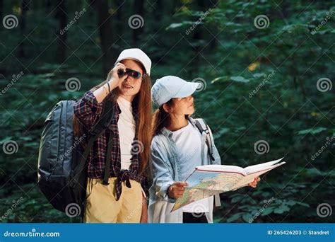Front View Of Two Girls That Is In The Forest Having A Leisure Activity