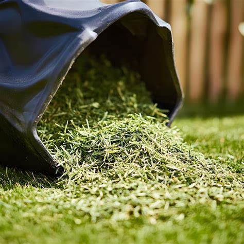 A Blue Bag Is Laying On The Grass In Front Of A Fence Premium Ai