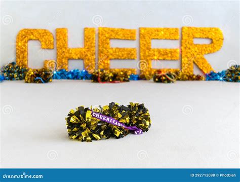 Gold And Black Pompoms With Cheerleader And Large Gold Sparkly Cheer