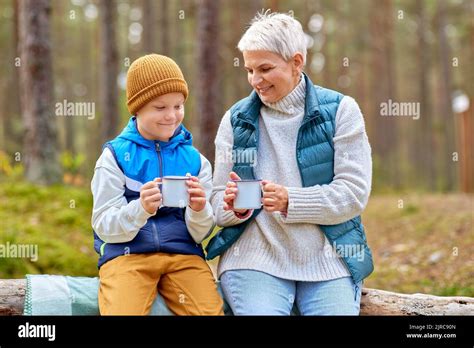 Grandmother With Grandson Drinking Tea In Forest Stock Photo Alamy