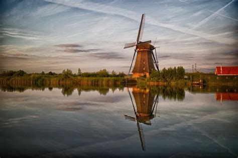 A Windmill Sitting In The Middle Of A Lake