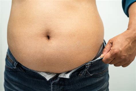 Overweight Asian Woman Show And Use Hand To Squeeze Fat Belly Stock