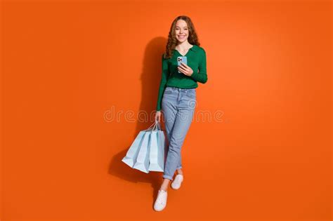 Photo Of Positive Cheerful Lady Dressed Green Shirt Holding Shoppers